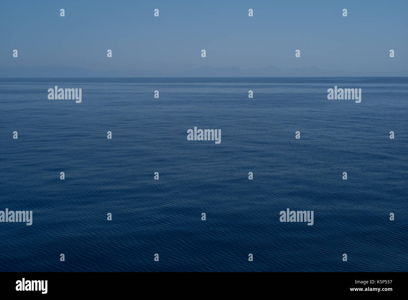 plain ocean with land in background Stock Photo - Alamy