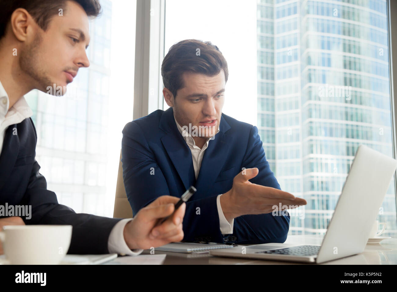 Auditor explaining results of audit to client Stock Photo - Alamy