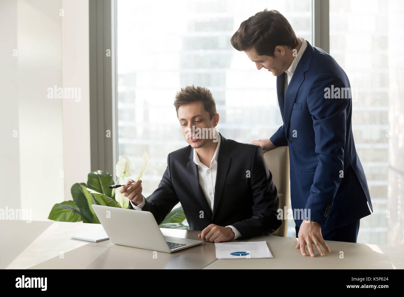 Boss listening interesting proposal of employee Stock Photo - Alamy