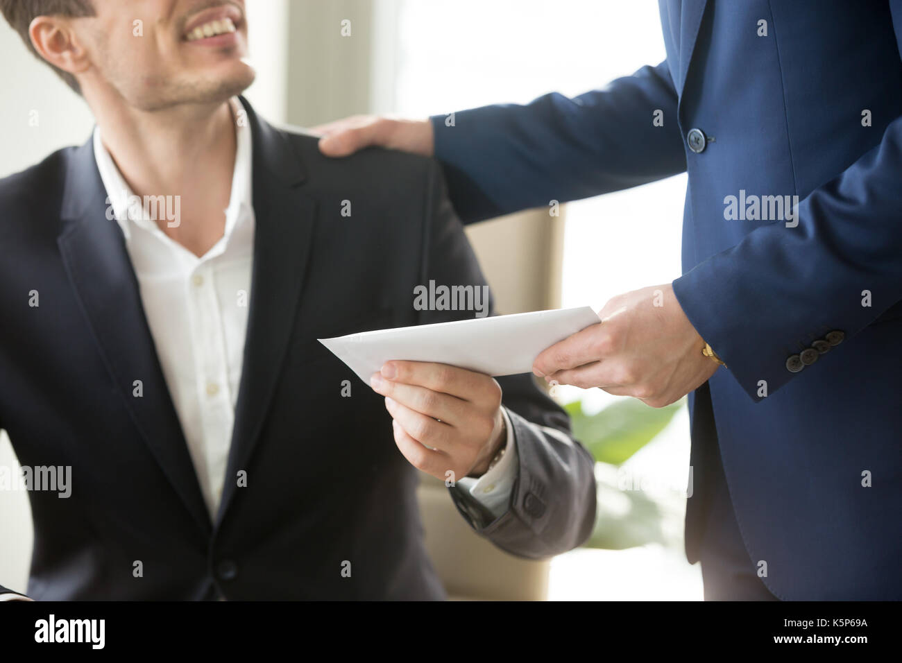 Boss congratulating employee with getting reward Stock Photo - Alamy