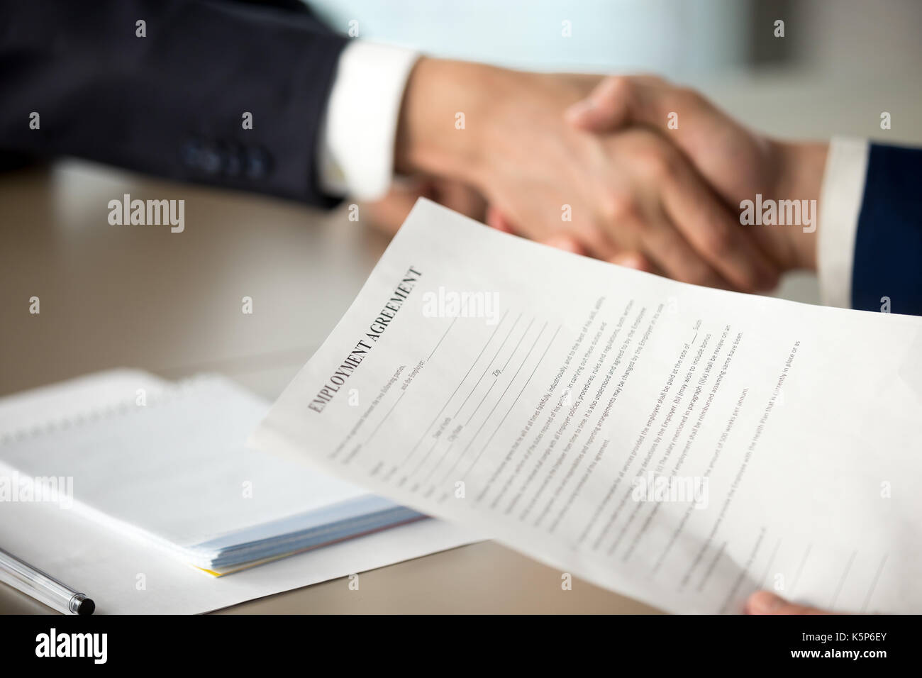 Boss handshaking and offering employment agreement Stock Photo - Alamy