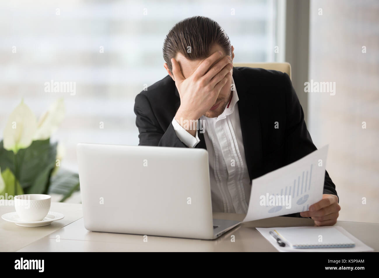 Stressed businessman facepalming because of failing financial re Stock ...