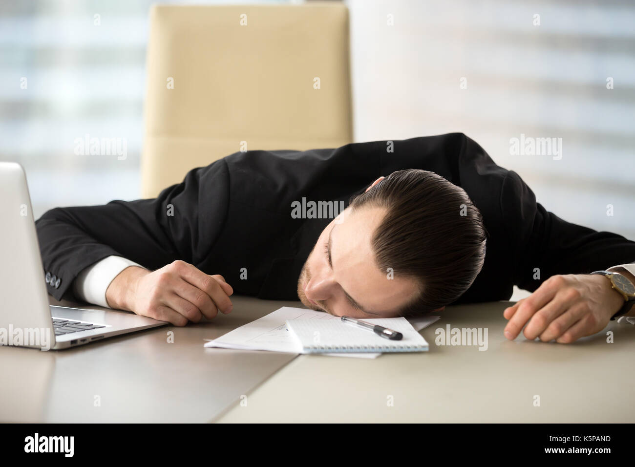 Exhausted businessman passed out at his work desk in office Stock Photo ...