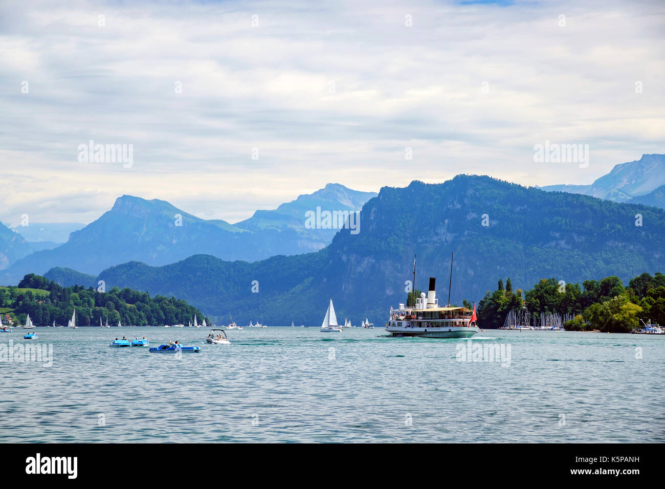 The beautiful Luzern lake with ships, boats, and birds at Luzern ...
