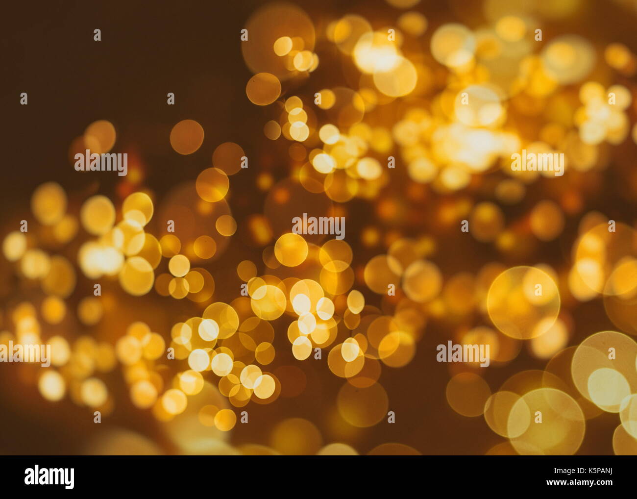 Festive background with natural bokeh and bright golden lights. Vintage ...