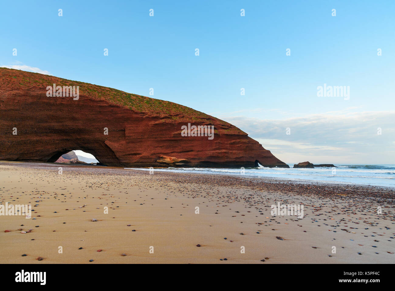 Legzira beach with huge arch of rock in the morning. Morocco Stock ...