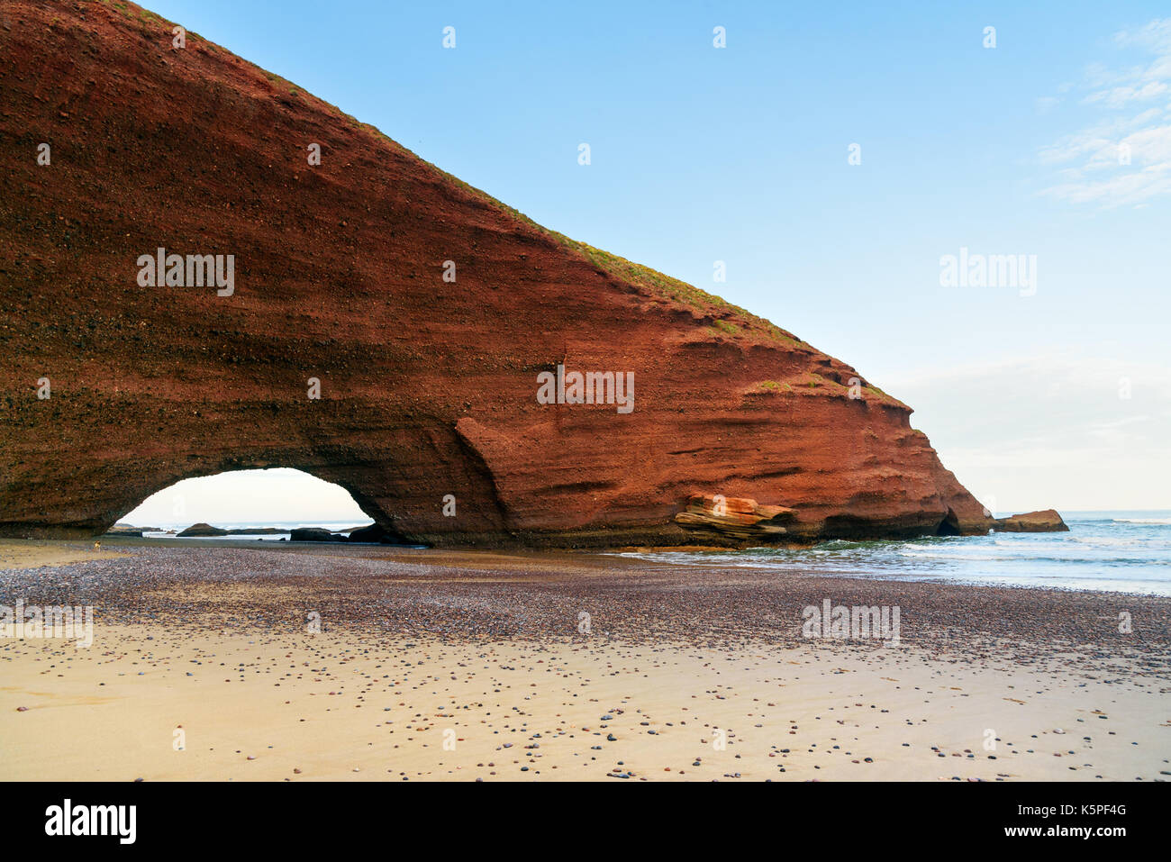 Legzira beach with huge arch of rock in the morning. Morocco Stock ...