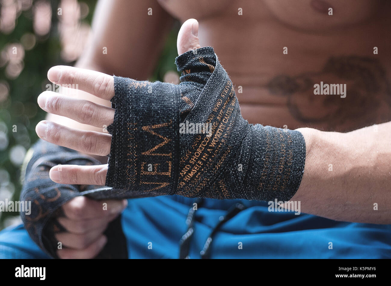 Close up of muscular male boxer wraps his hands in bandages Stock Photo ...