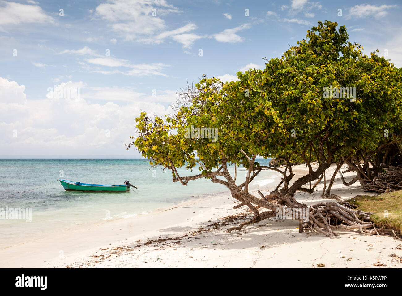 Tropical beach with a boat Stock Photo - Alamy