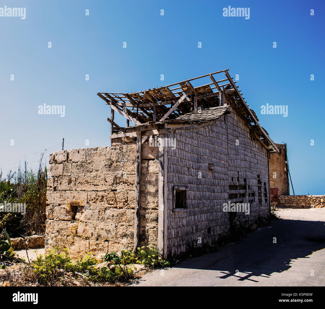 A collapsing countryside building made of Maltese stone and wood Stock ...