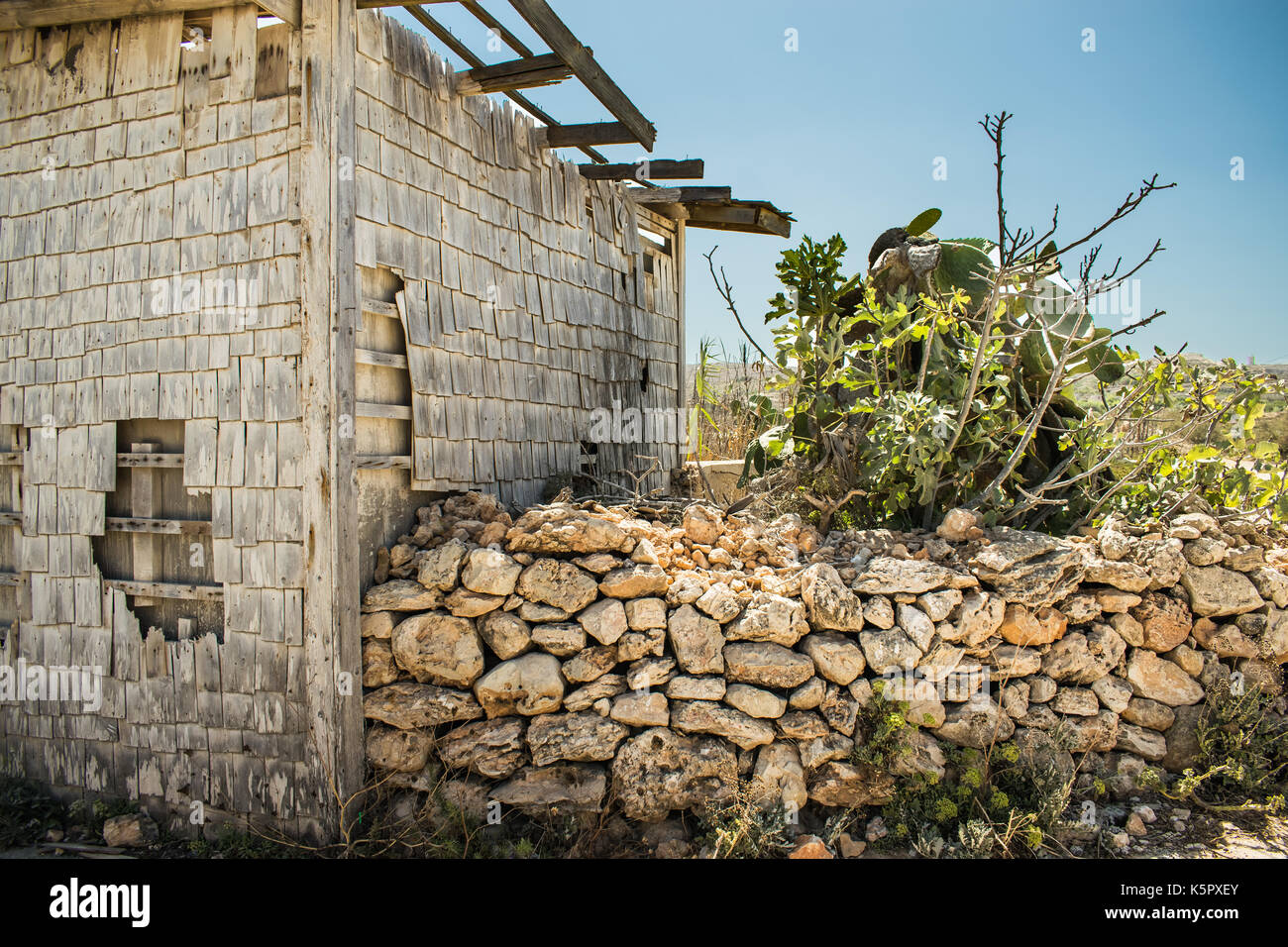 An old wall built using typical Maltese stone supporting a collapsing ...