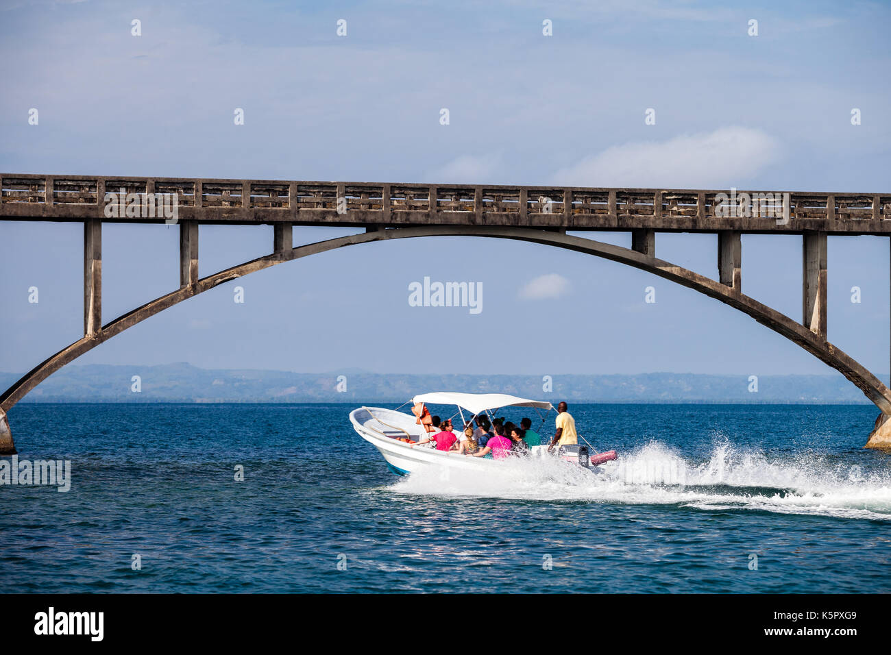 Boat crossing a bridge Stock Photo - Alamy