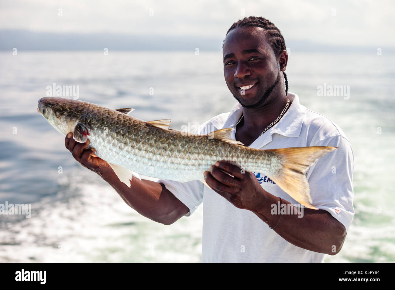 Men showing a fish Stock Photo - Alamy