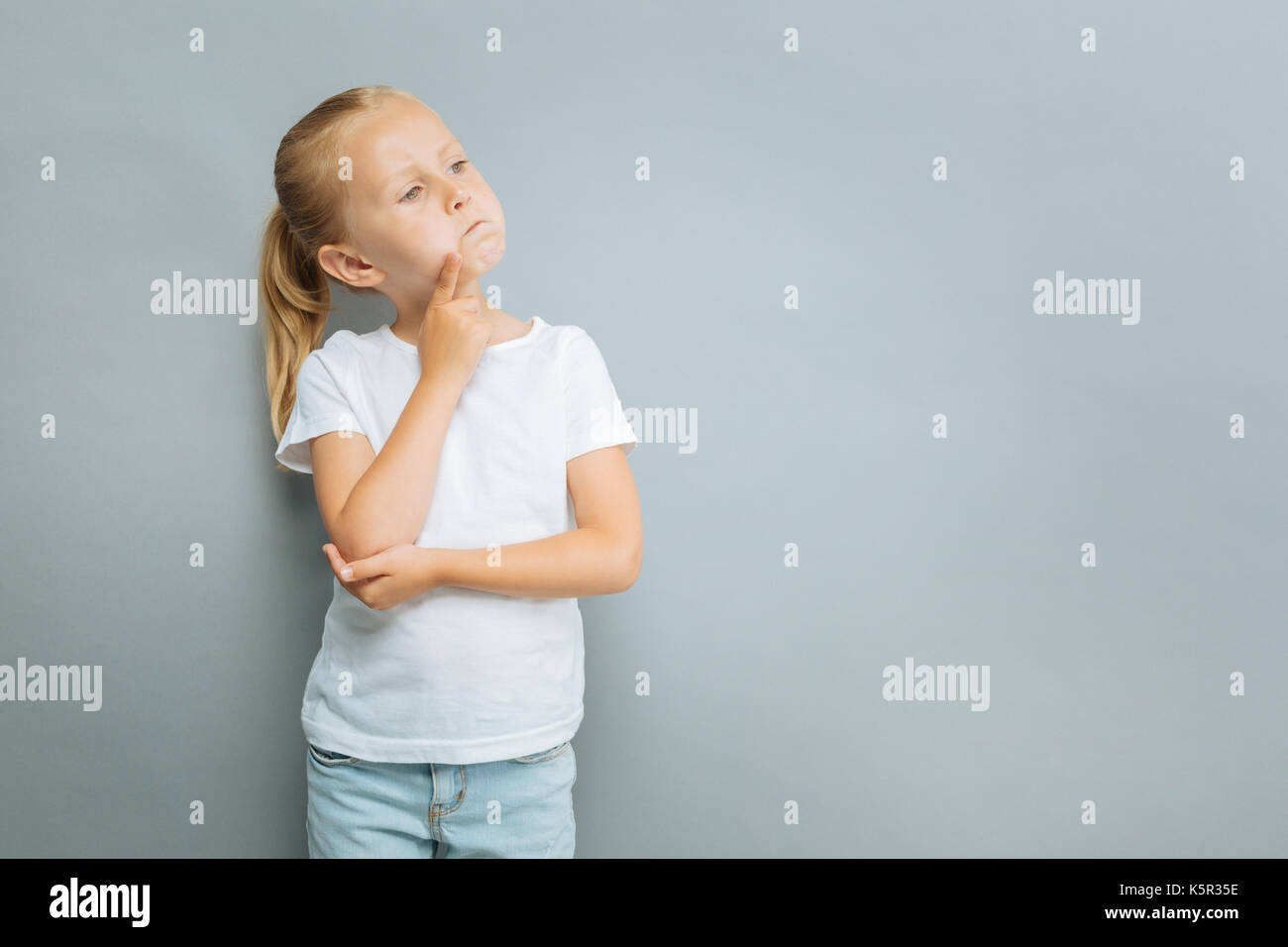 Little girl making serious face Stock Photo - Alamy