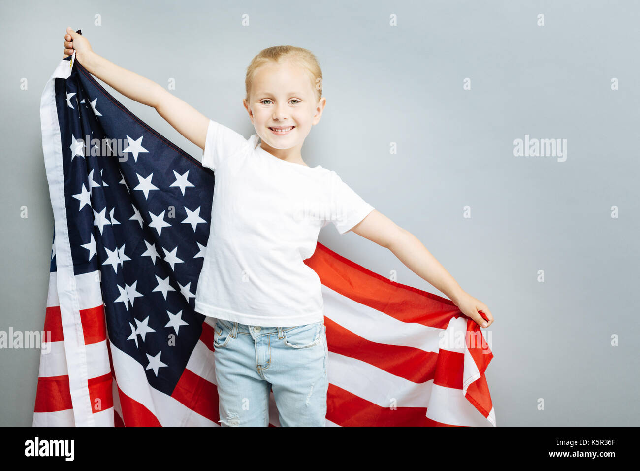 Patriotic child holding national flag Stock Photo - Alamy