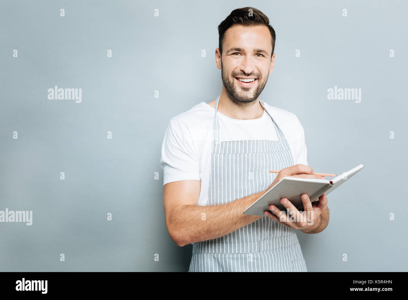 Attractive male making some notes Stock Photo - Alamy