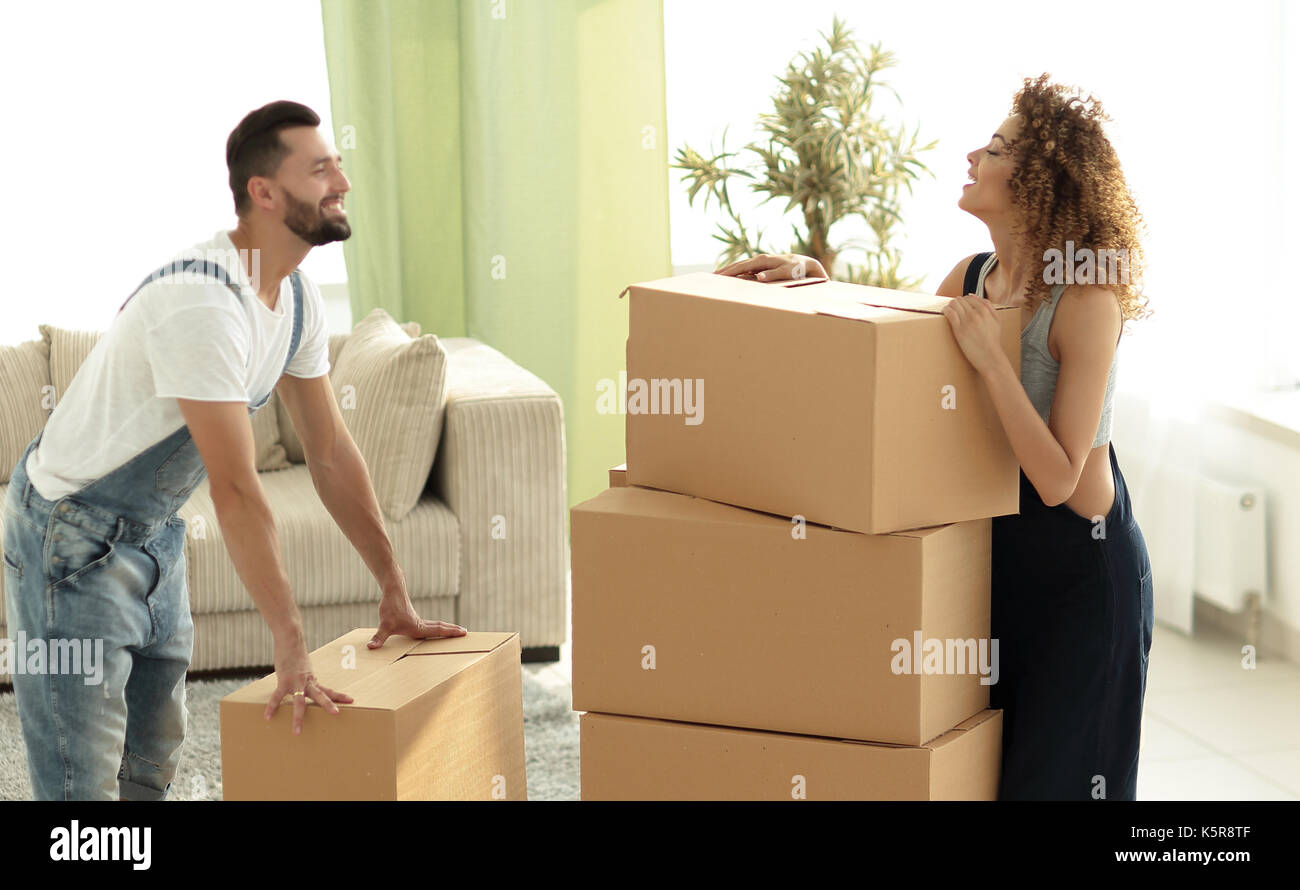 Happy and young couple looking at boxes Stock Photo - Alamy