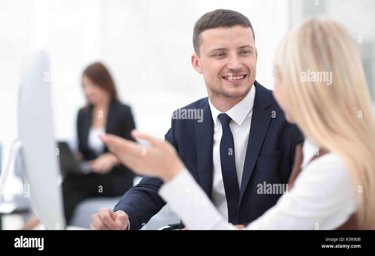 Manager talking with a colleague at the workplace Stock Photo - Alamy