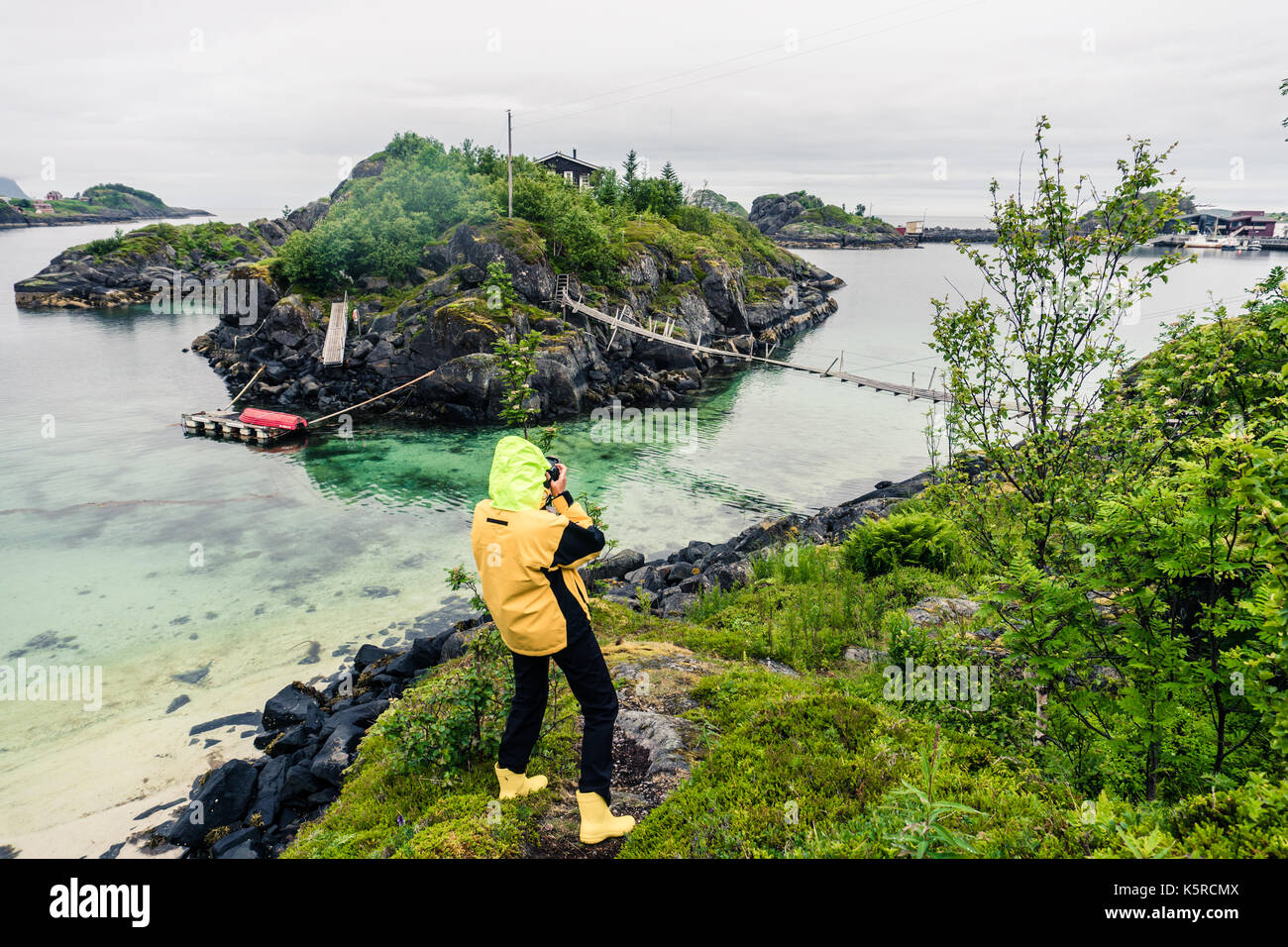 Human photographing a suspension bridge to the island Stock Photo - Alamy