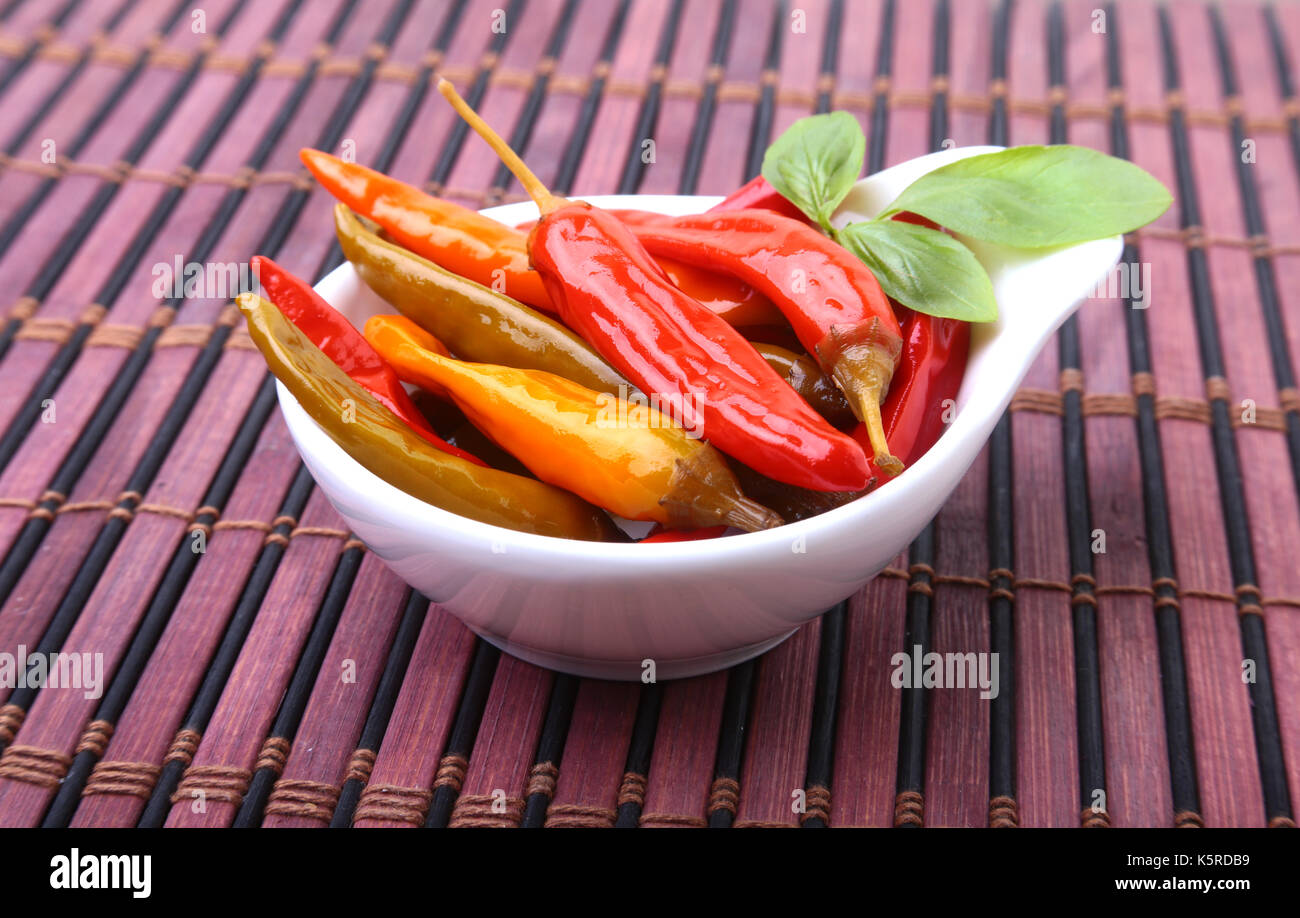 Bowl of pickled Red hot chili peppers on wooden background Stock Photo ...