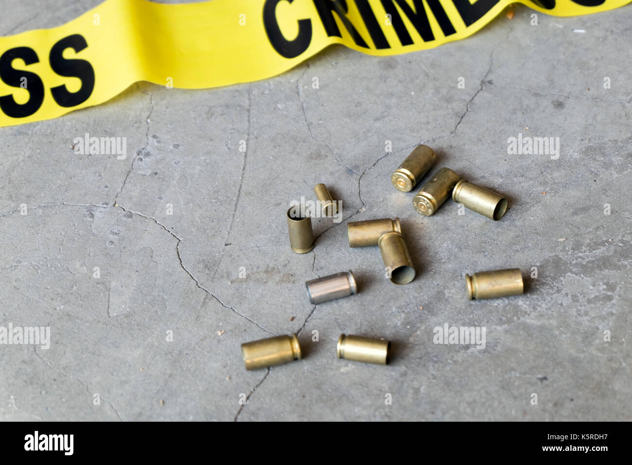 Crime scene concept with crime tape and casings Stock Photo - Alamy
