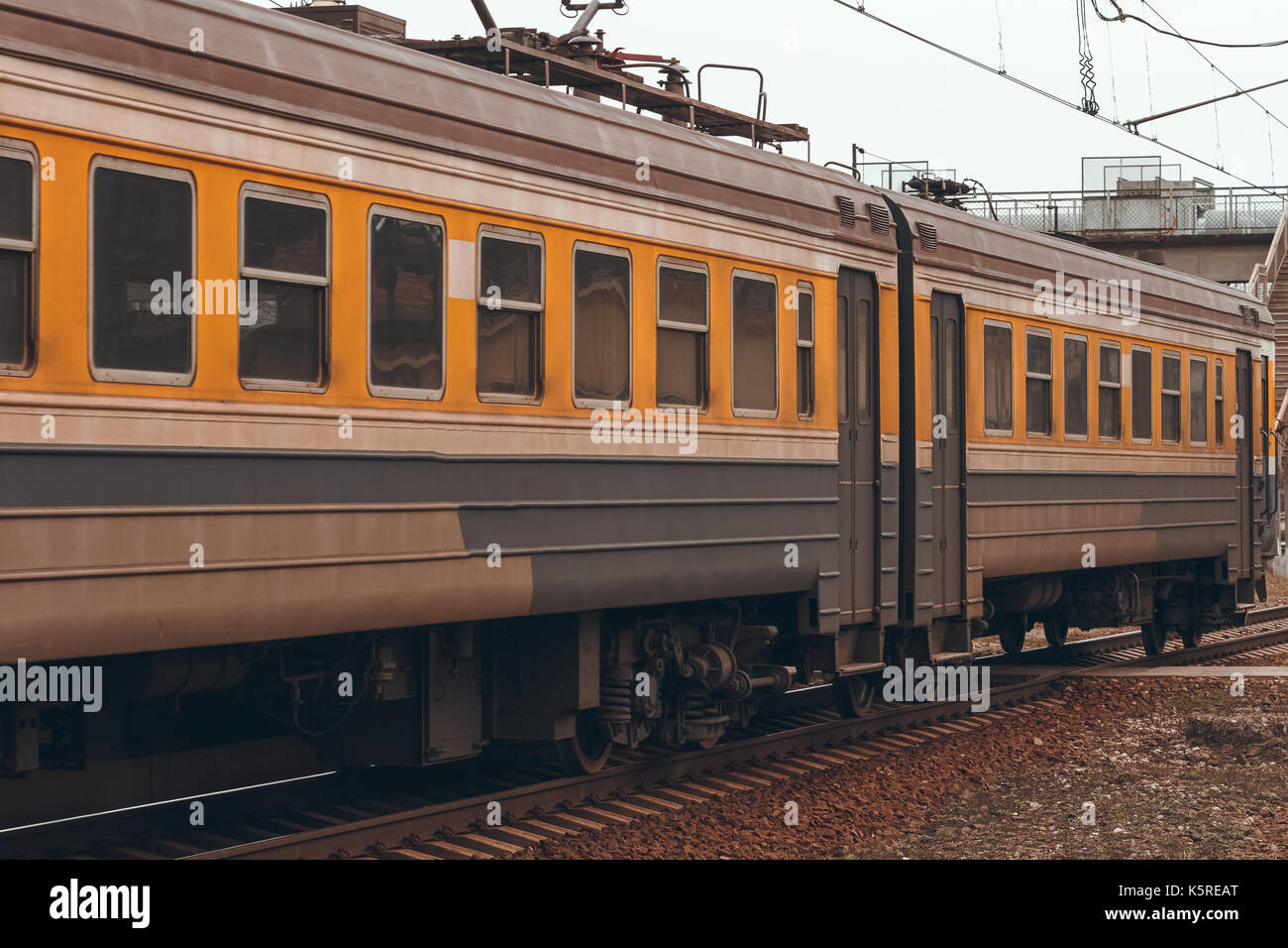 Old yellow passenger electric train driving at the terminal Stock Photo ...