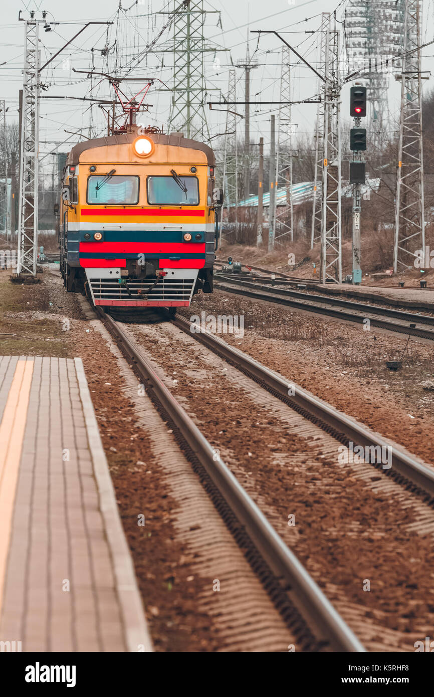 Old yellow passenger electric train driving at the terminal Stock Photo ...