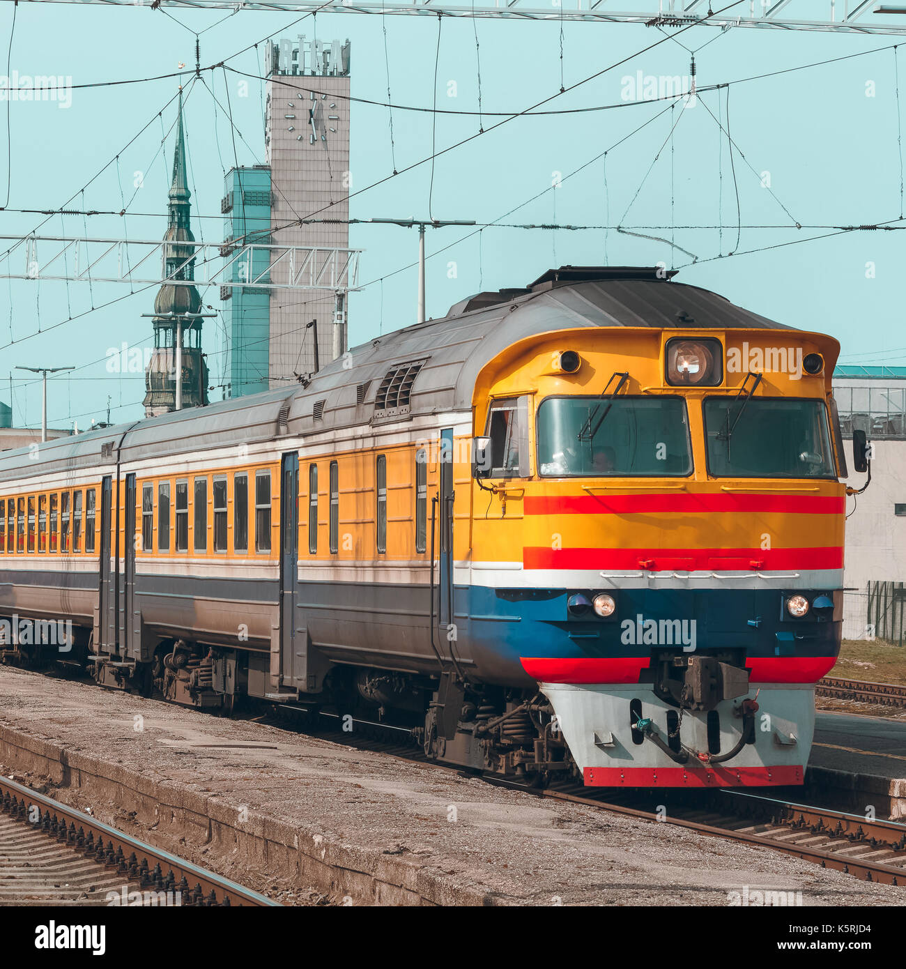Old yellow passenger diesel train moving at the terminal Stock Photo ...