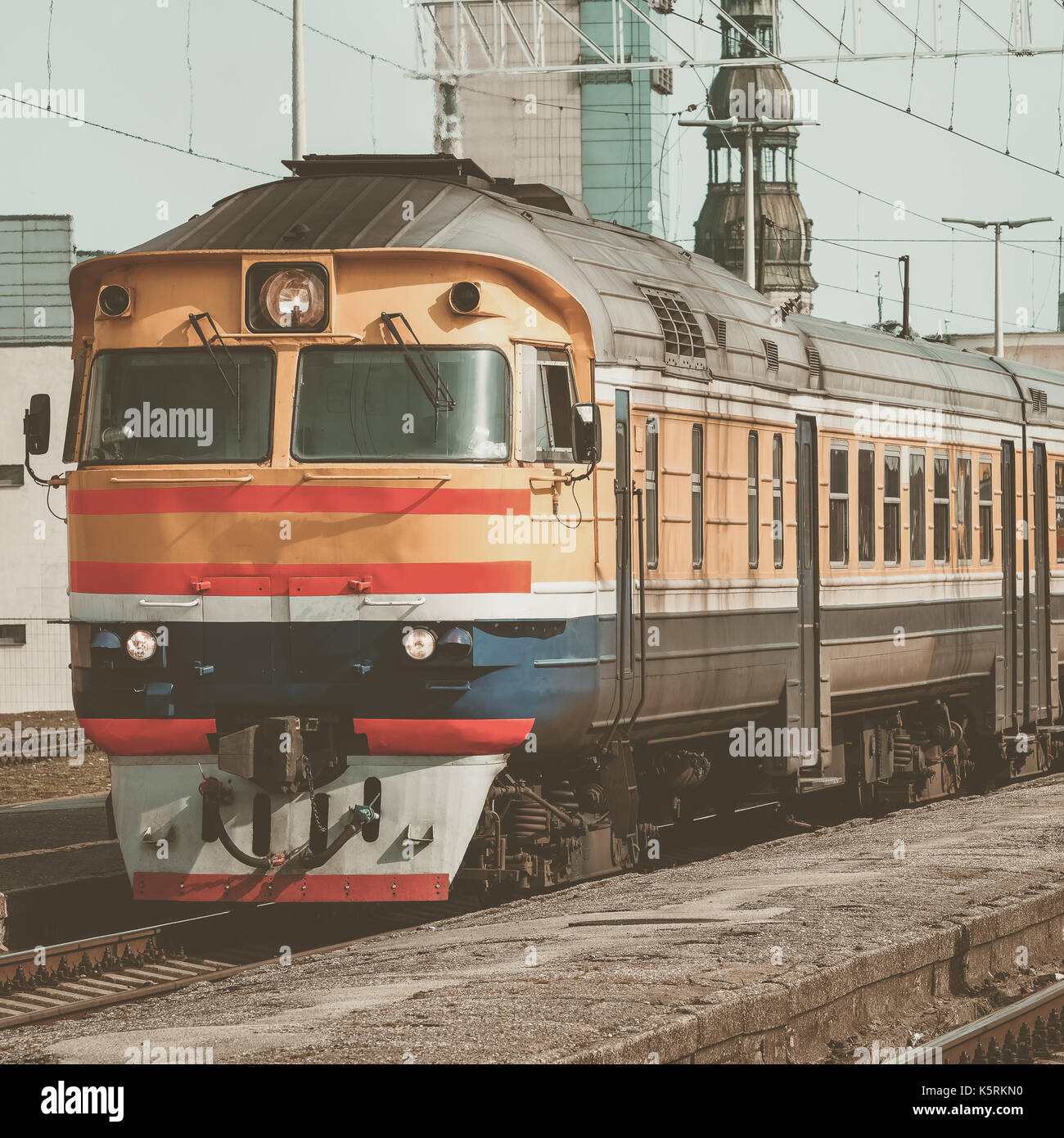Old yellow passenger diesel train moving at the terminal Stock Photo ...