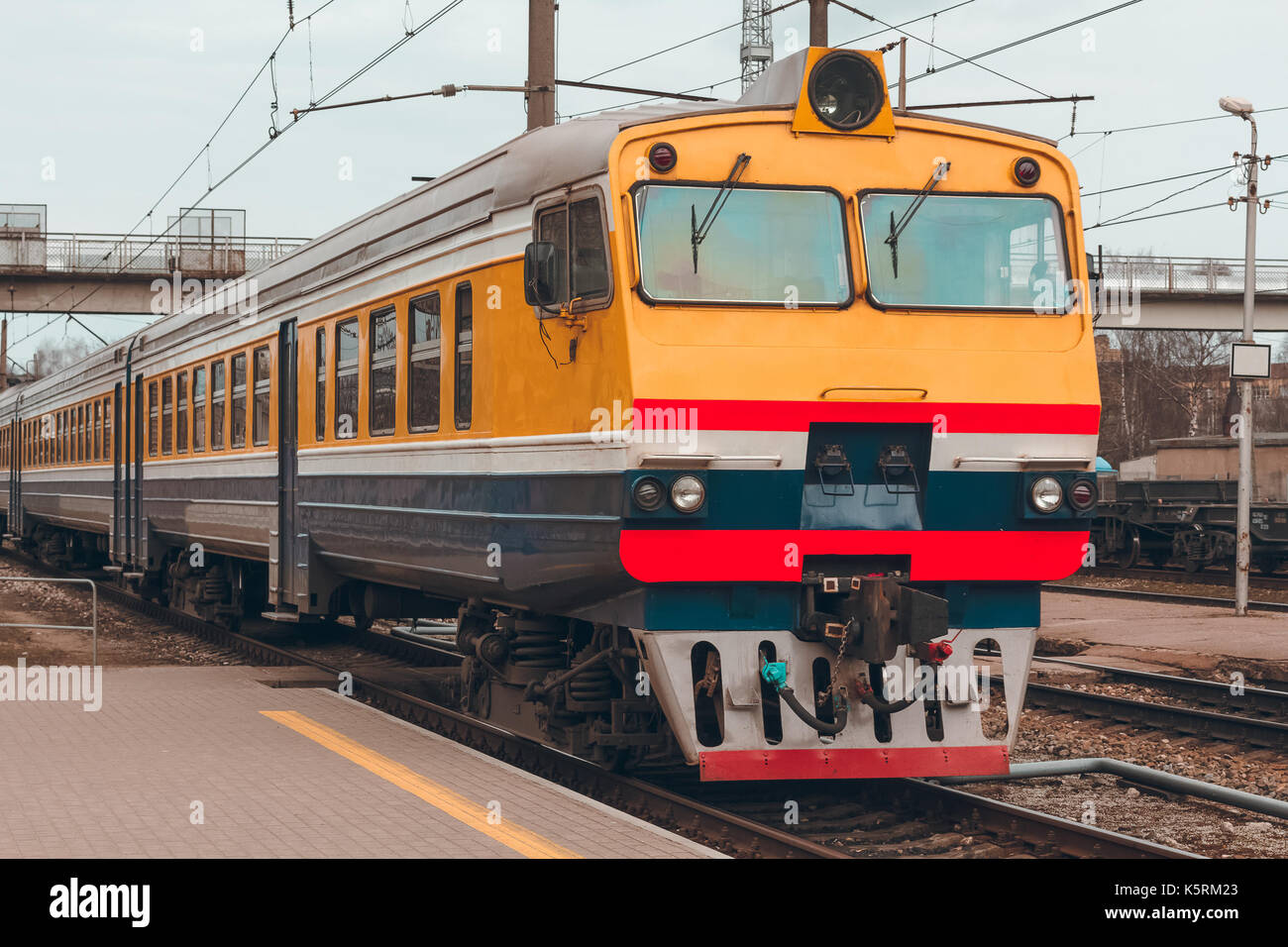 Old yellow passenger diesel train moving at the terminal Stock Photo ...