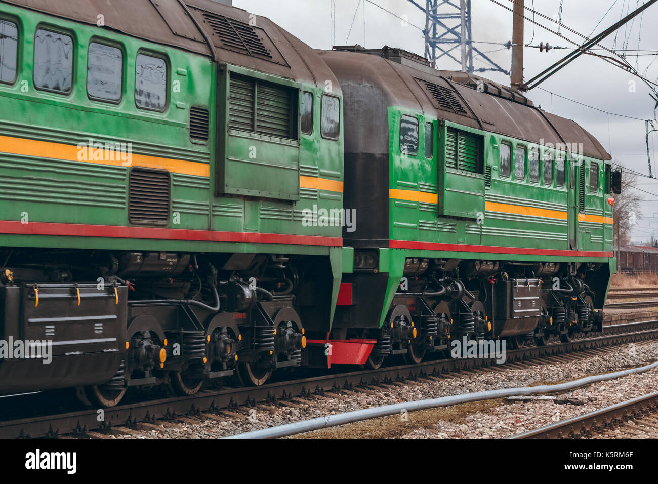 Green diesel cargo locomotive. Freight train in action Stock Photo - Alamy