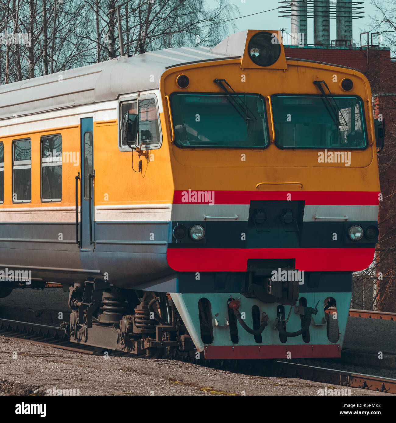 Old yellow passenger diesel train moving at the terminal Stock Photo ...