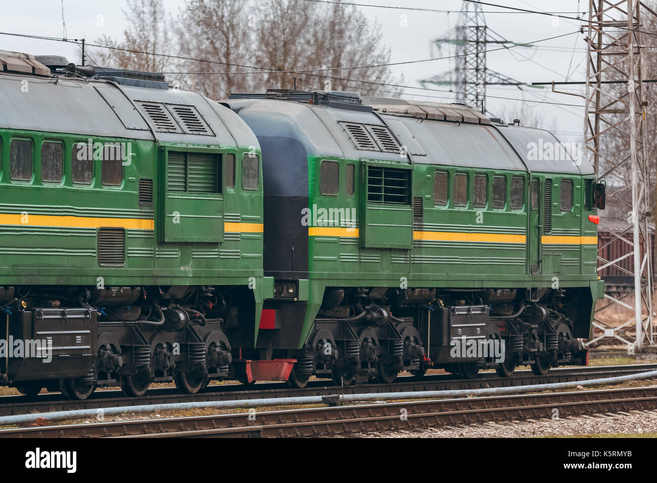 Green diesel cargo locomotive. Freight train in action Stock Photo - Alamy