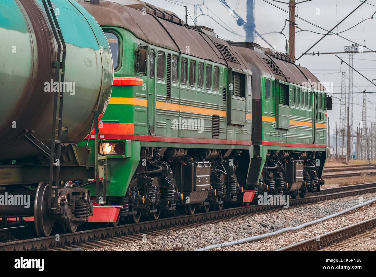 Green diesel cargo locomotive. Freight train in action Stock Photo - Alamy