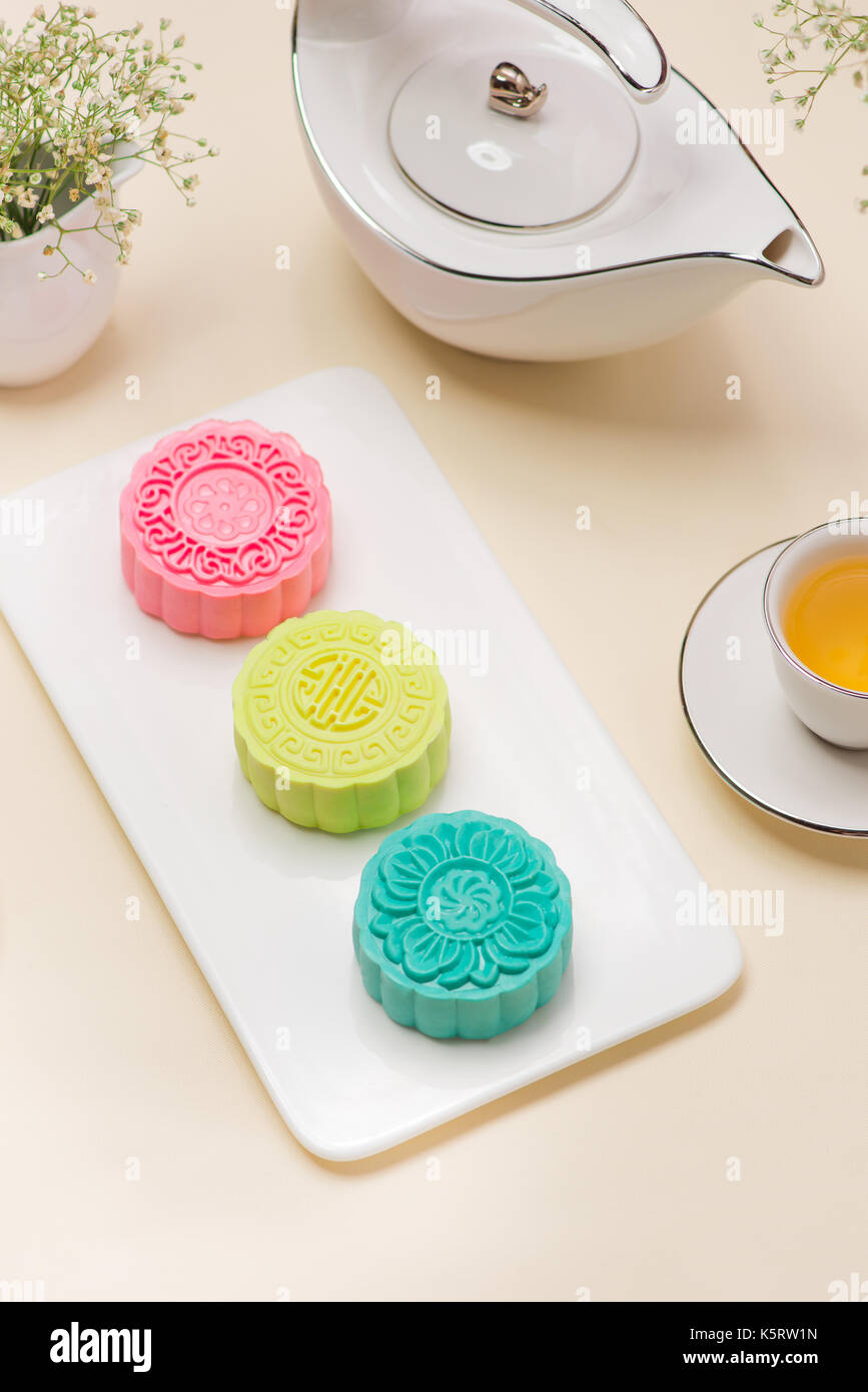 Colorful snow skin mooncake with tea pot on pink background Stock Photo ...