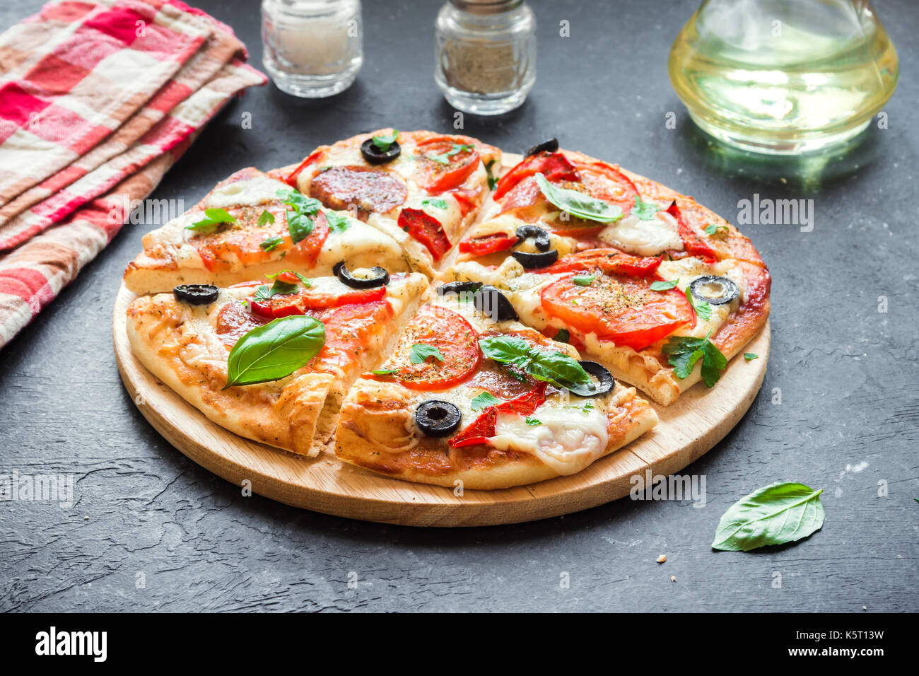 Italian Pizza with Tomatoes, Salami, black Olives and Mozzarella Cheese ...