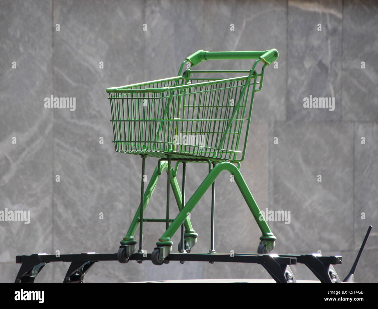Green Shopping Trolley Isolated Mounted on Car Rooftop Stock Photo - Alamy