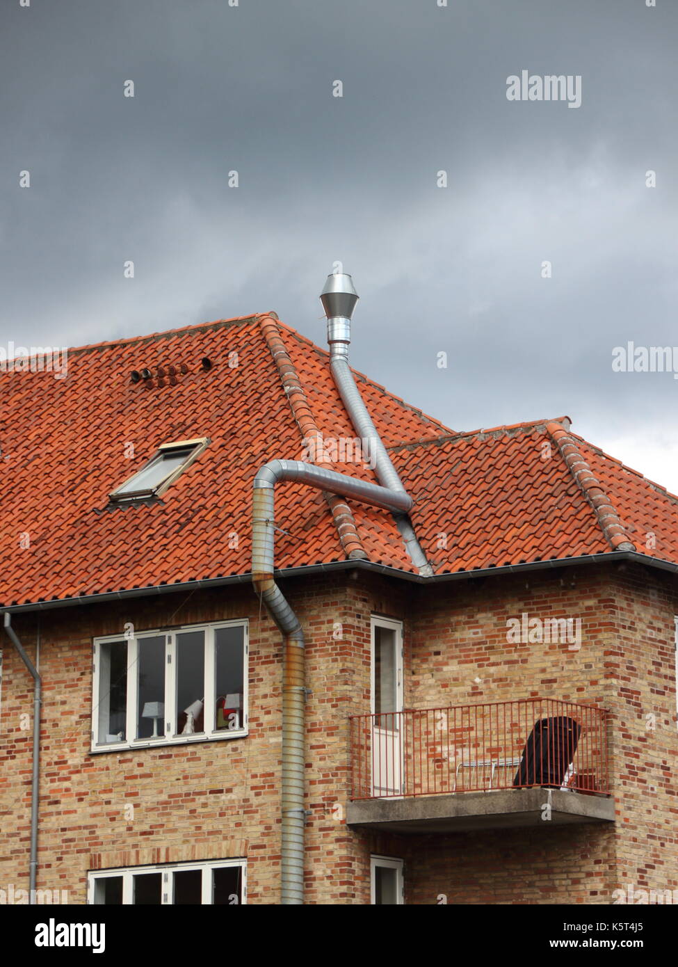 Twisted Metal Chimney on Red Tile Roof with Overcast Sky Stock Photo ...