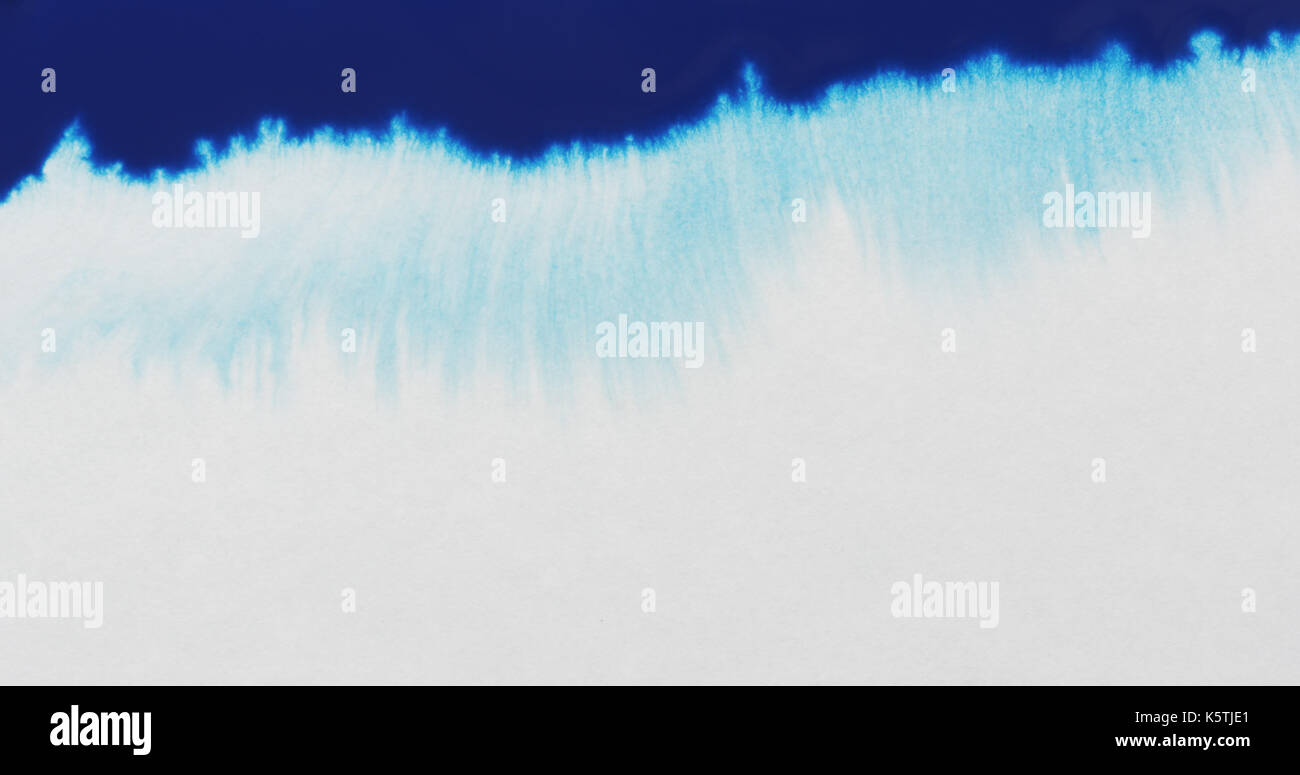 closeup blue ink border spreading on wet paper top view, wide photo ...