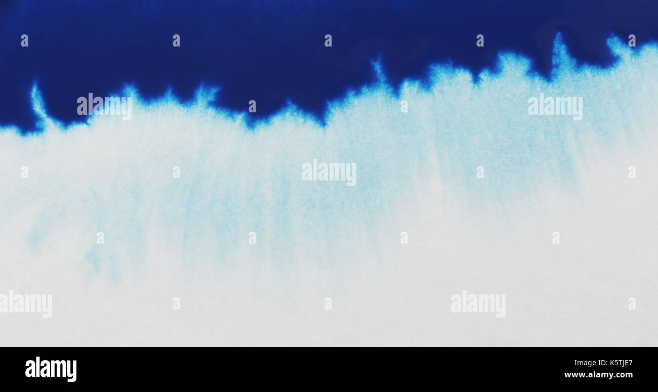 closeup blue ink border spreading on wet paper top view, wide photo ...