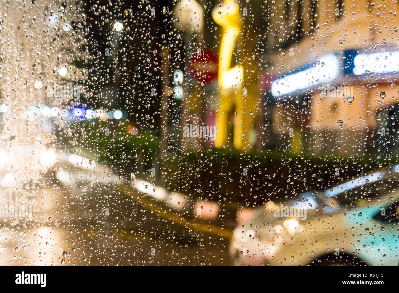 out of focus buildings shot through rain drops. Perfect for showing a ...
