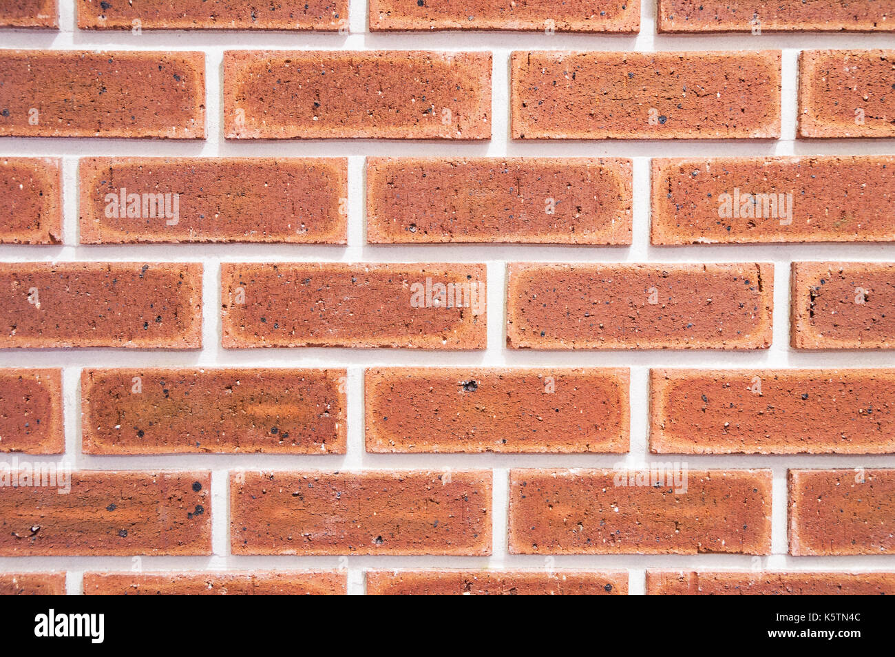 Brick wall background, texture of red stone blocks closeup Stock Photo ...