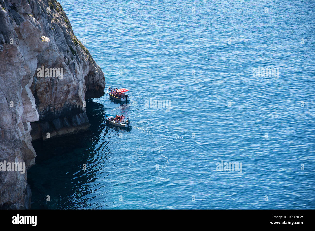 BLUE GROTTO, MALTA - AUGUST 23, 2017: Tourists taking a boat trip at ...