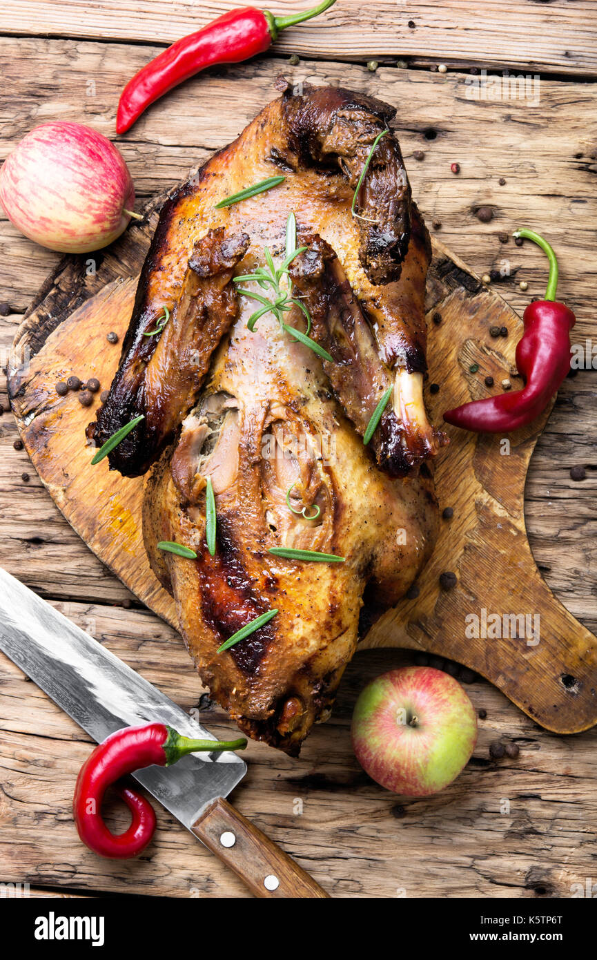 roasted duck with apples on the kitchen cutting board Stock Photo - Alamy