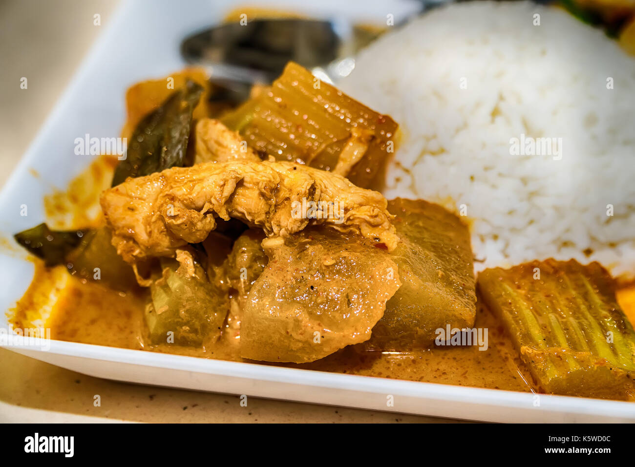 Chicken Curry and rice on a white plate Stock Photo - Alamy