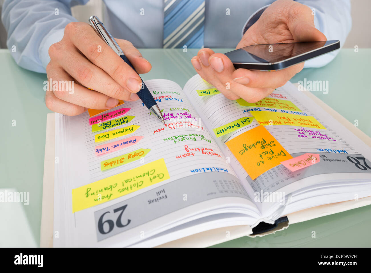 Close-up Of A Businessman Writing Schedule In Diary Stock Photo - Alamy