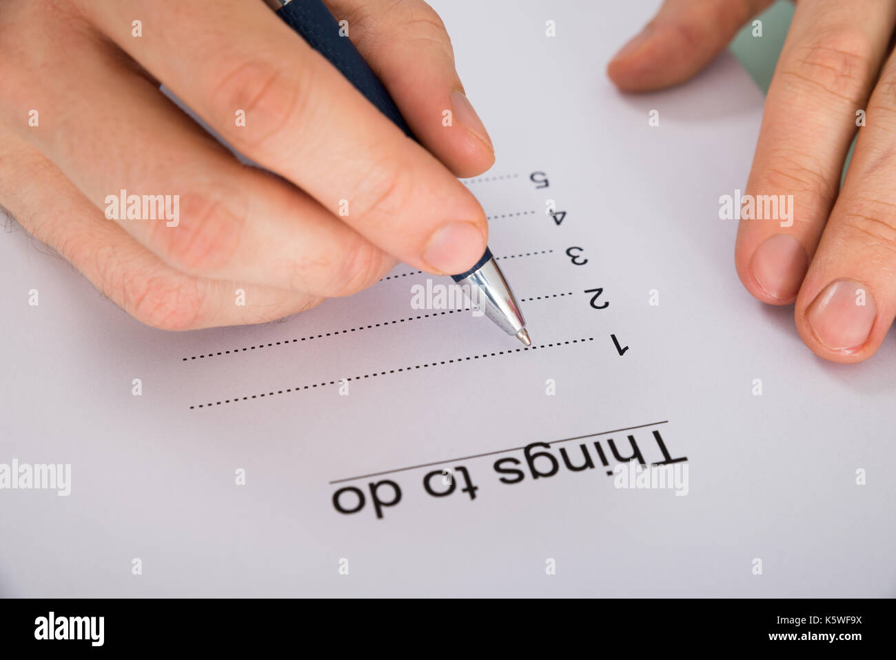 Close-up Of Person's Hand Writing Things To Do List On Paper Stock ...