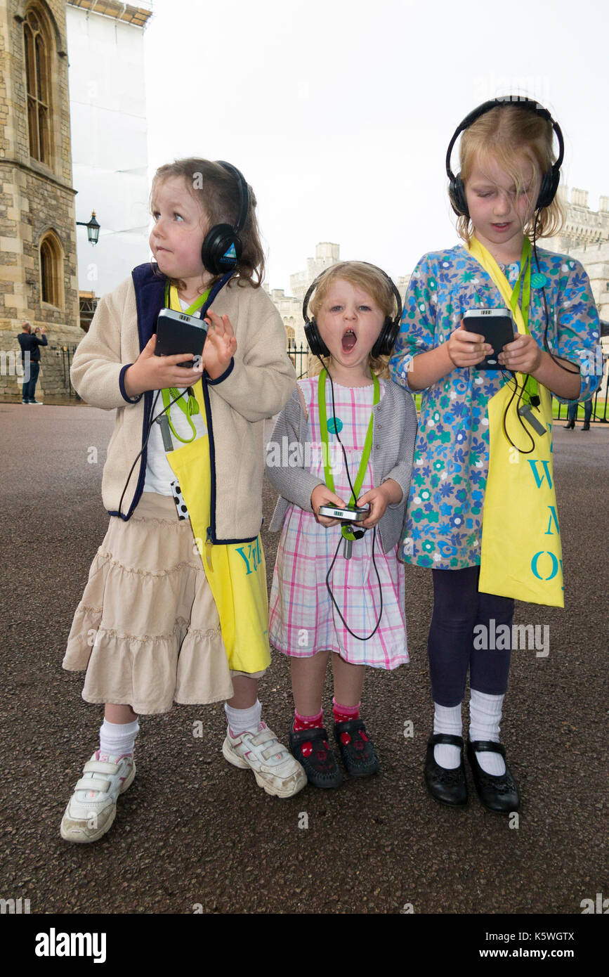 One yawns / yawn / yawning as 3 sisters / children / kid / kids on ...