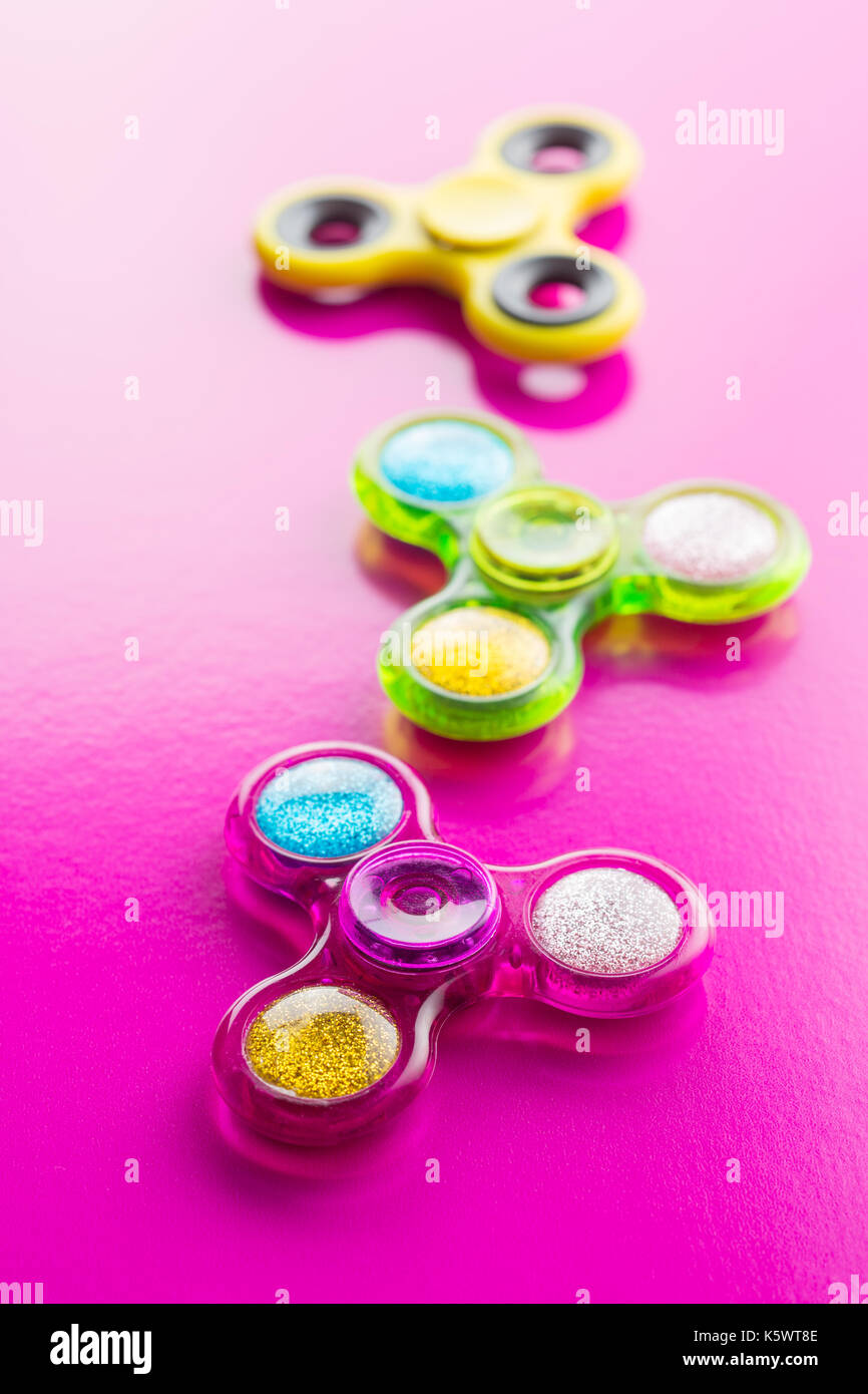 Fidget finger spinners stress on pink background Stock Photo - Alamy Fidget finger spinners stress on pink background Stock Photo - Alamy