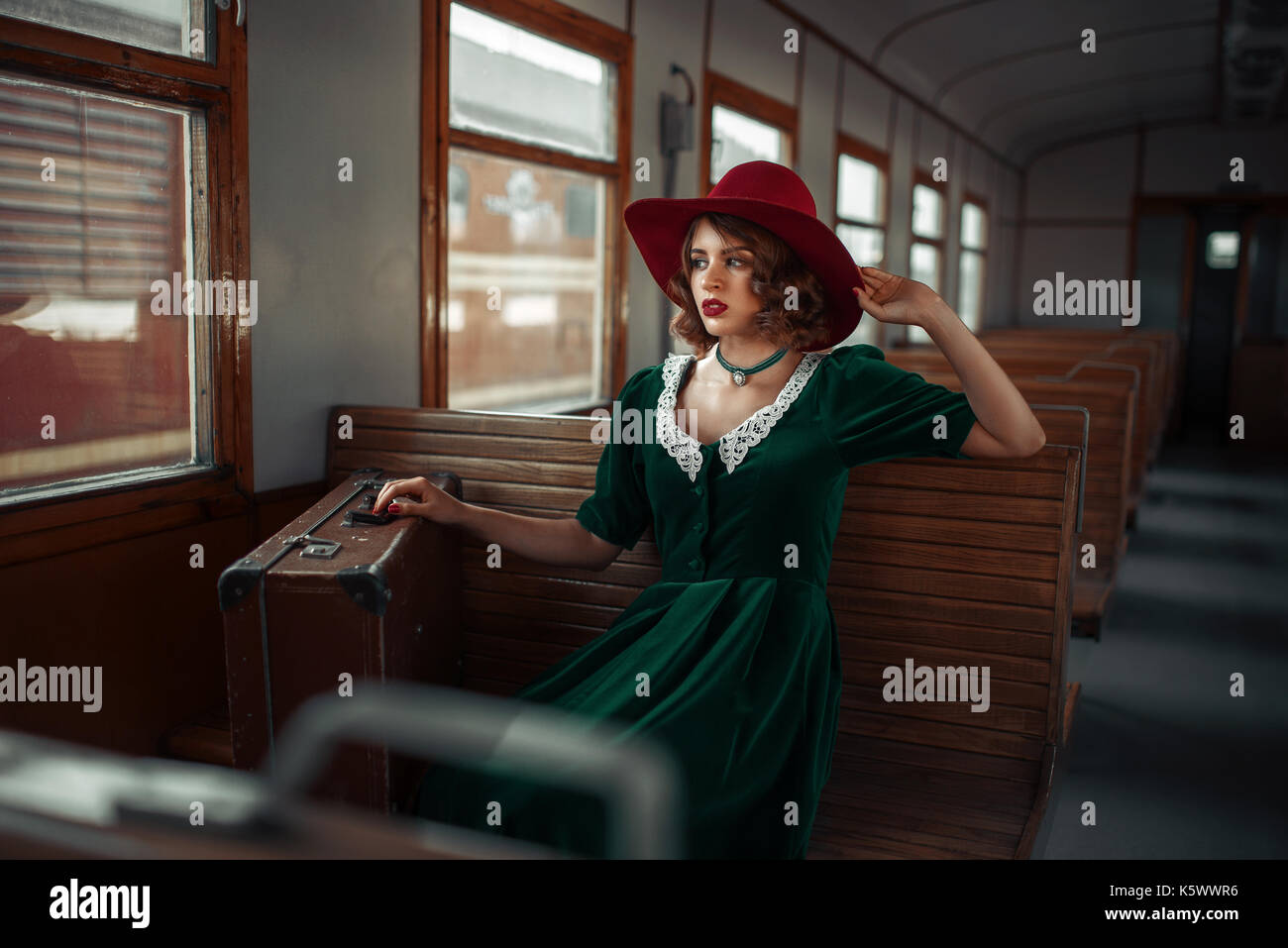 Beautiful woman in retro train, old wagon interior. Railroad voyage ...